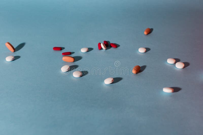 Tablets Falling Down on Blue Background Stock Photo - Image of bunch ...