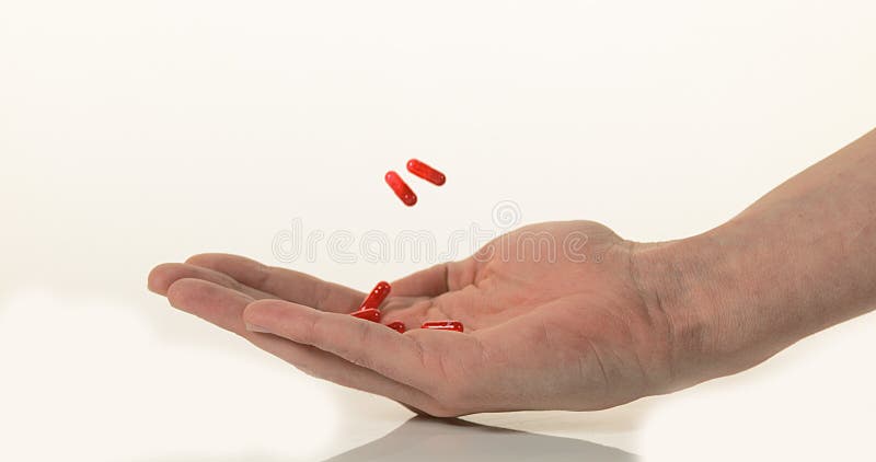 Tablets Falling into Hand Against White Background Stock Image - Image ...