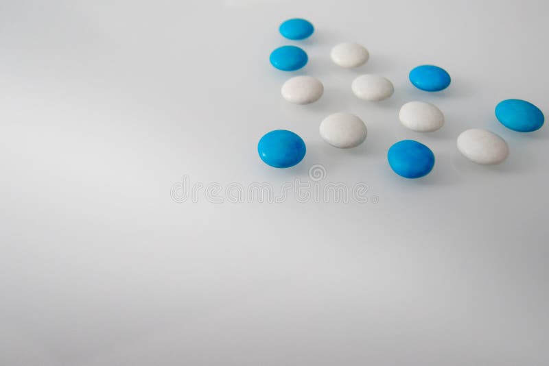 Tablets or Sweets, White and Colored on a White Table Stock Photo ...