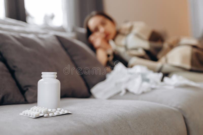 Tablets for Treatment, in the Background a Sick Girl Wrapped in a ...