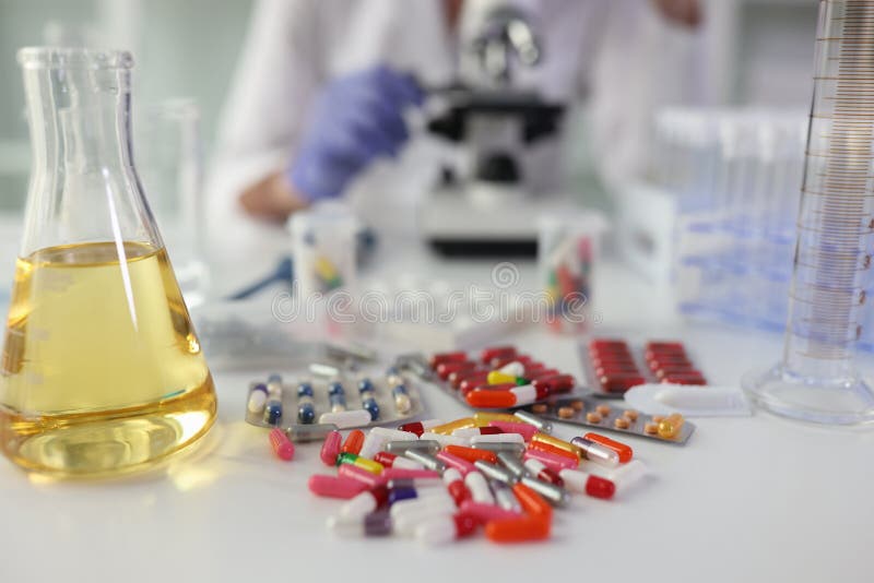 Tablets and Yellow Oil in a Flask on a Table in the Laboratory Stock ...