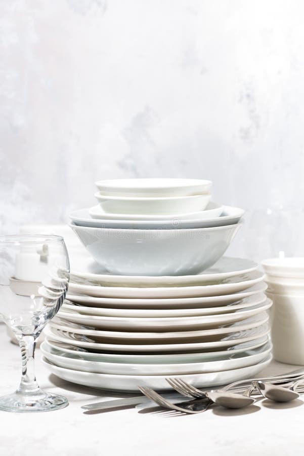 Tableware, Cutlery and Glasses on a White Table, Vertical Stock Image ...