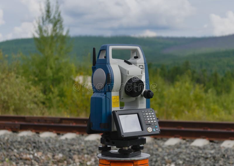 Tachymeter Making Geodetic Survey with Summer Forest at the Background ...