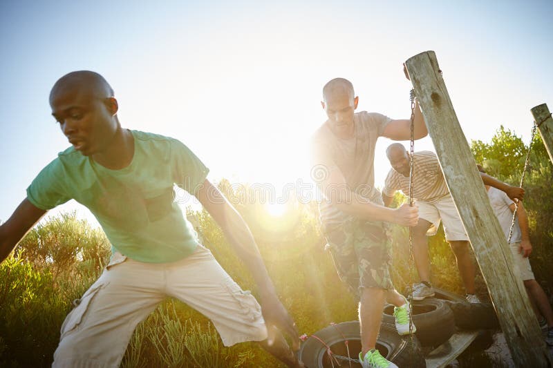 Tackling the Obstacle Course with Determination. a Group of Young Men ...