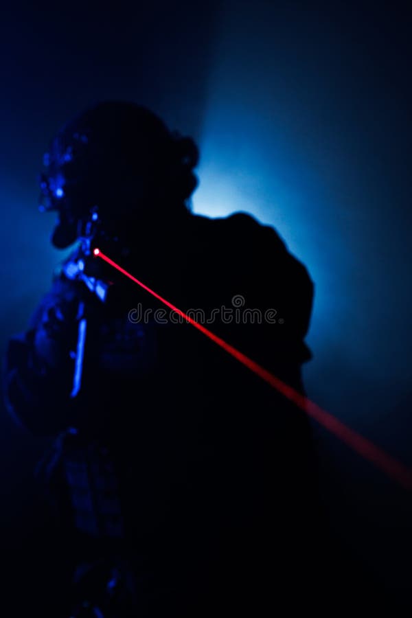 Tactical Figure with Red Laser Beam in Dramatic Low Light Setting Stock ...