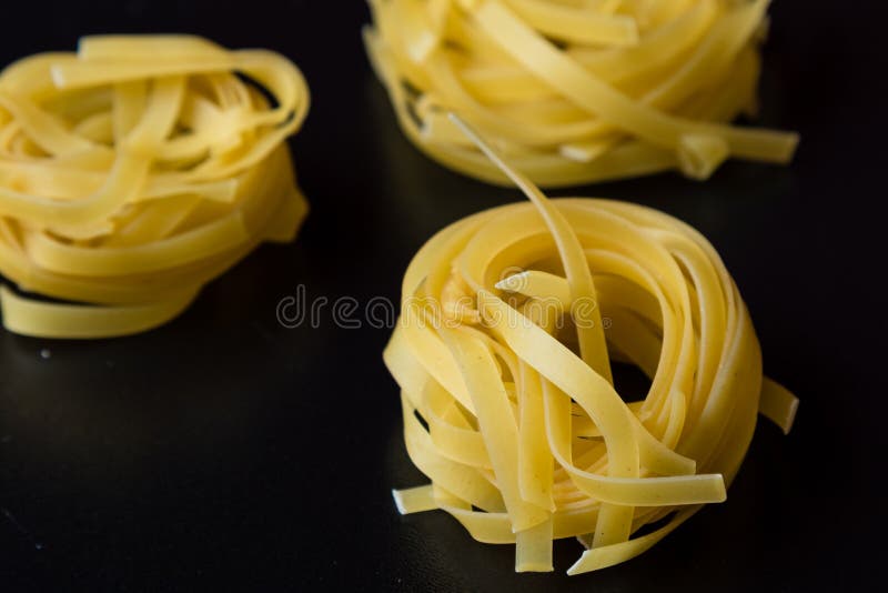 Tagliatelle on black table stock image. Image of healthy - 69208909