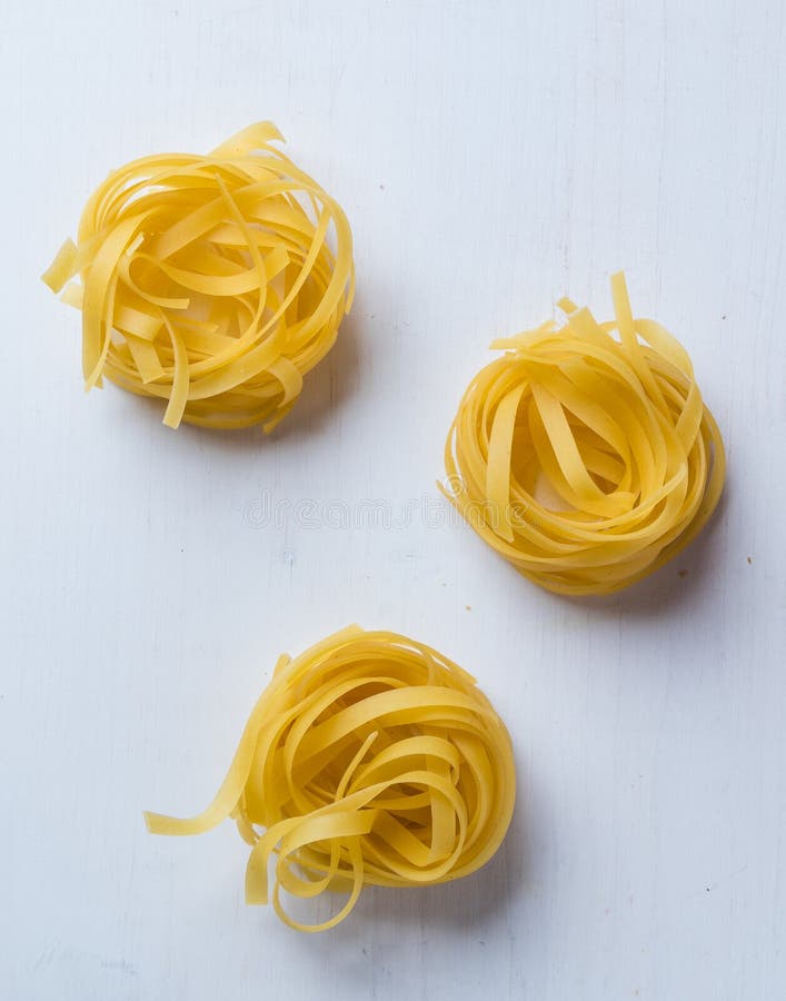 Tagliatelle on white table stock image. Image of fettuccine - 69208819