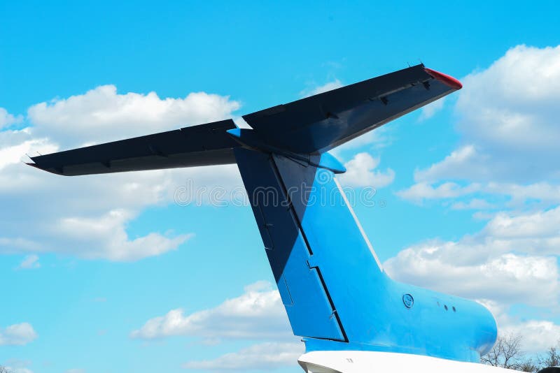 Tail of a Jet Airplane in Front of Sky Background with Flying Airplane ...