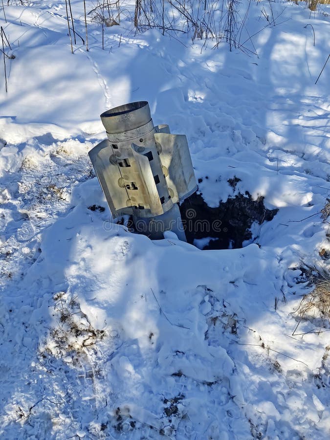 The Tail of a Rocket Sticking Out of the Snow. Unexploded Shell. Rocket ...
