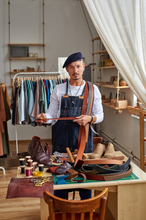 Tailor in Apron Working with Leather Belt at Workshop, Craftsman Stock ...