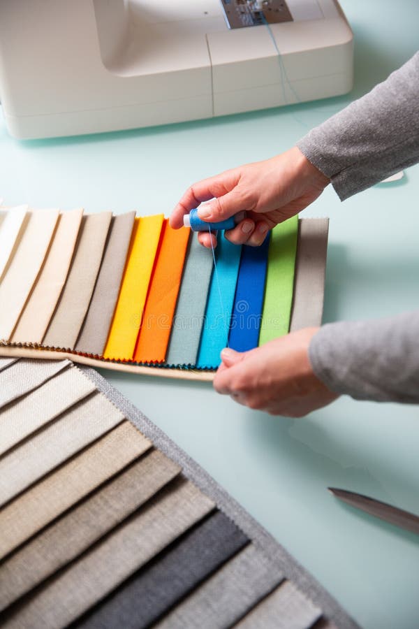 Tailor Choosing Right Color of a Blue Thread Using Fabric Samples on ...