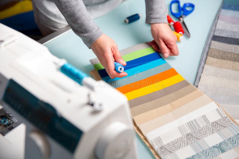 Tailor Choosing Right Color of a Blue Thread Using Fabric Samples on ...