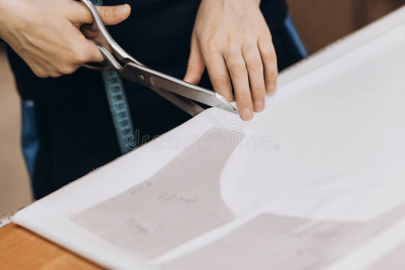 The Tailor Cuts Out the Fabric According To the Pattern Stock Photo ...