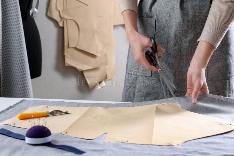 Tailor Cutting Fabric with Scissors at Table in Atelier, Closeup Stock ...