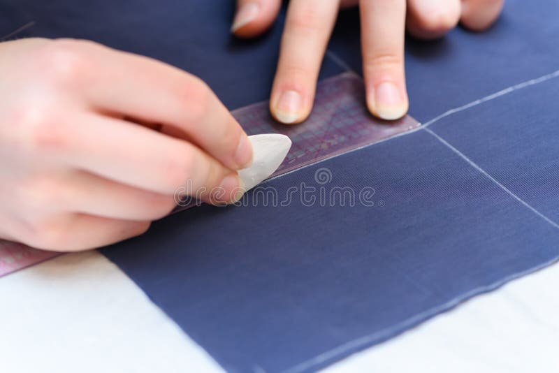 A Tailor Hand Marks Line on the Fabric with Chalk for Cutting a Garment ...