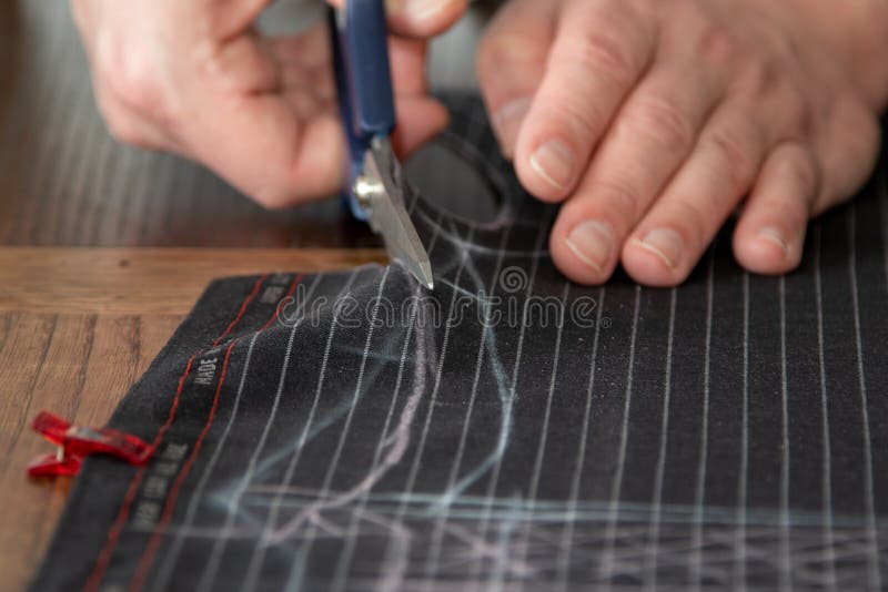 Tailor Hands Cutting Fabric Using Large Scissors or Shears As he ...