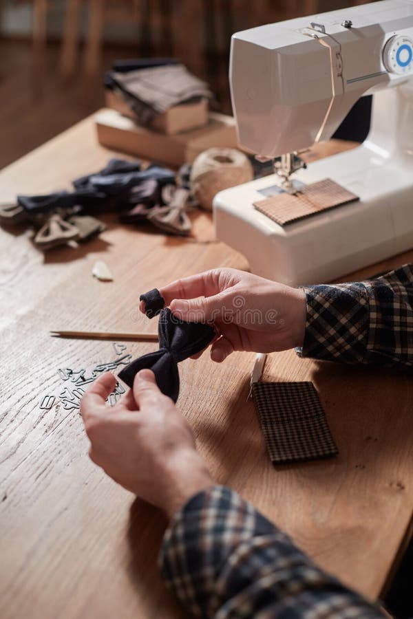 Tailor Makes Bow Ties of Woolen Fabric. Work with Sewing Machine in a ...