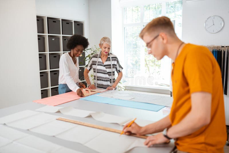Tailor Making a Paper Pattern in a Studio Stock Image - Image of busy ...