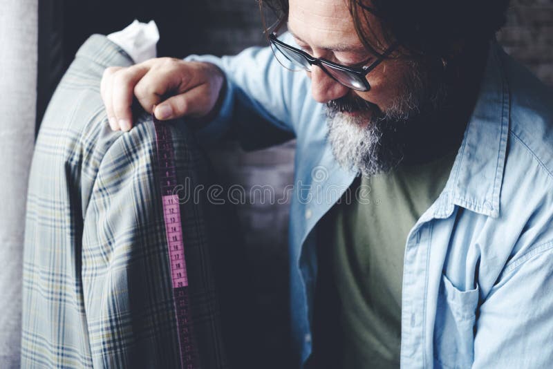 Tailor Man at Work Taking Measures on Garment in the Workshop ...