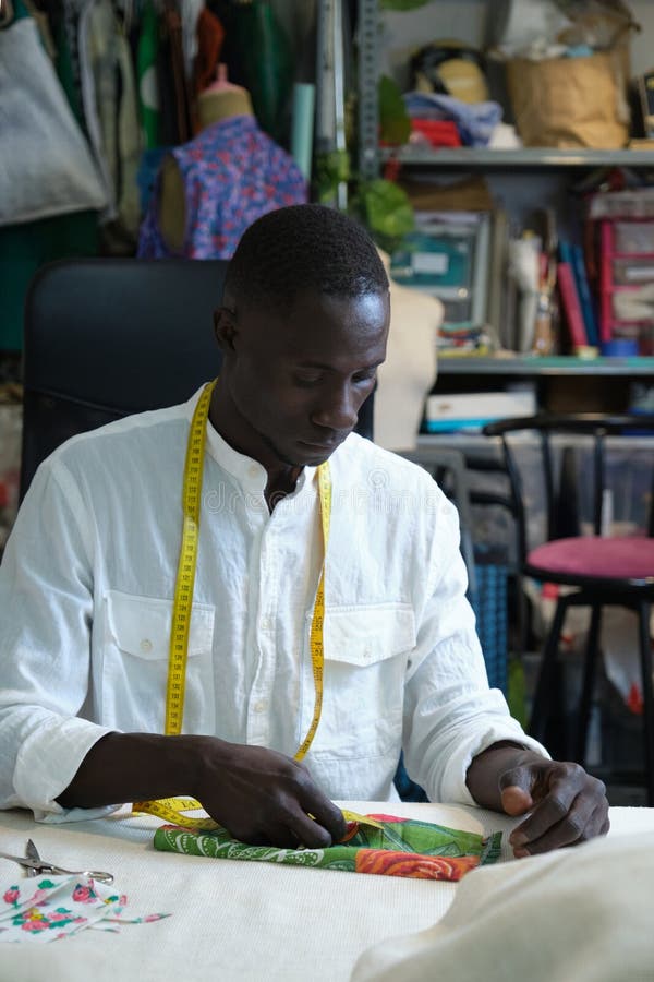 A Tailor Measuring Fabric in His Sewing Shop Using a Measure Tape ...