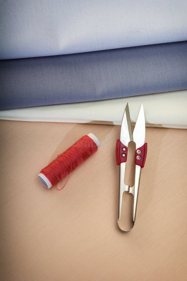 Tailor`s Scissors for Cutting Threads with a Piece of Fabric. Stock ...
