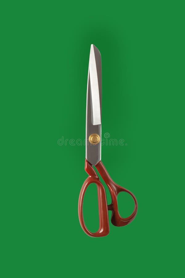 Tailor`s Scissors with a Red Handle on a Neutral Green Background ...