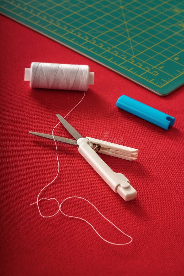 Tailor`s Scissors and Threads Lie on a Fabric Blank Against the ...