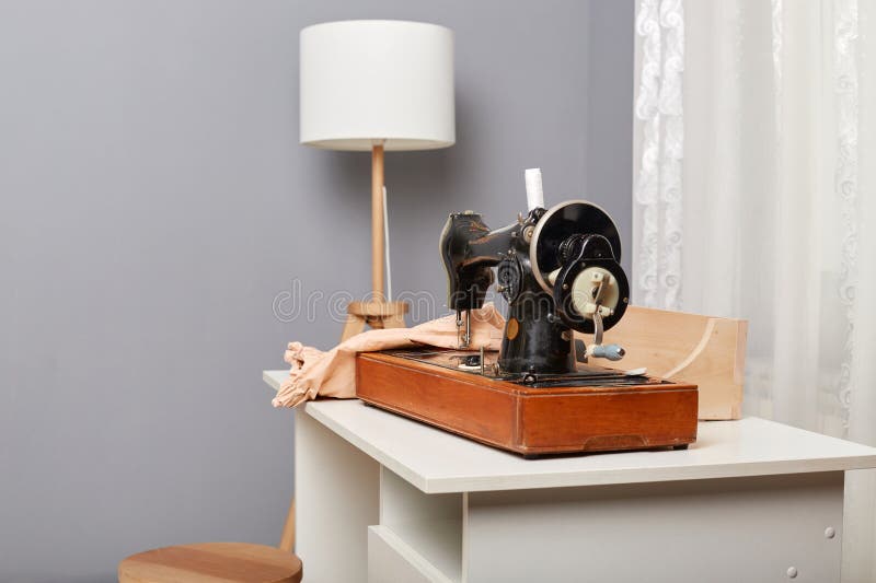Tailor S Workplace with Sewing Machine and Clothing on Table in Atelier ...