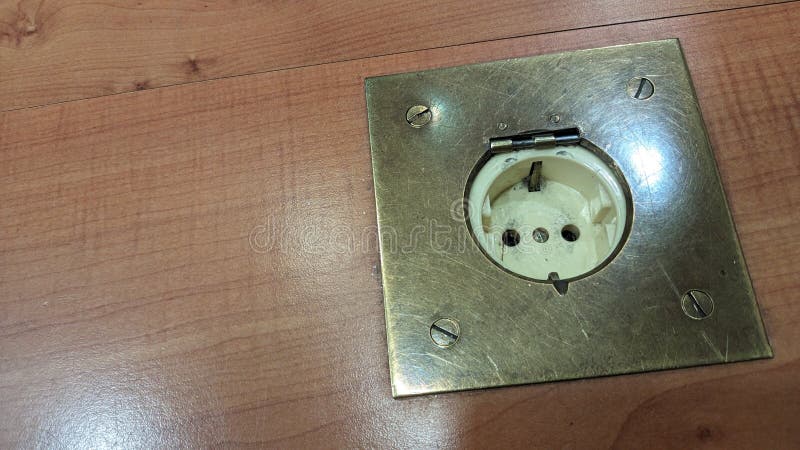 Electrical Outlet Made of Bronze Installed in the Floor in Wooden ...