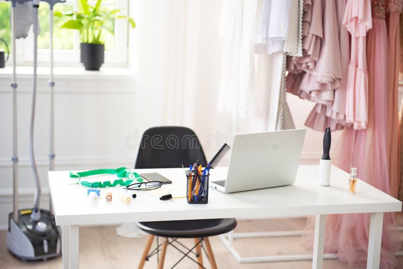 Tailor S Workspace with a Sewing Table, Laptop, Thread Spools ...