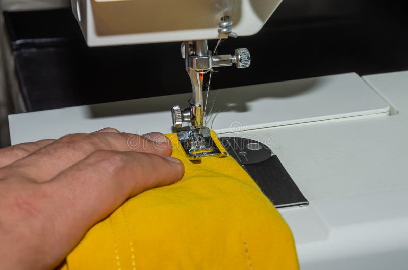 Tailor Sews Fabric for Clothing on a Sewing Machine in a Tailor Shop ...