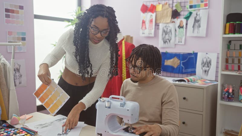 In a Tailor Shop, a Man and Woman Work Together among Sewing Patterns ...