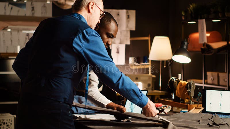 Tailor and Trainee Cutting Garment Stock Image - Image of workshop ...