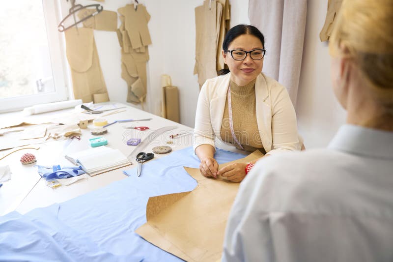 Tailoring Master Greets a Lady Fashion Designer at Her Workplace Stock ...