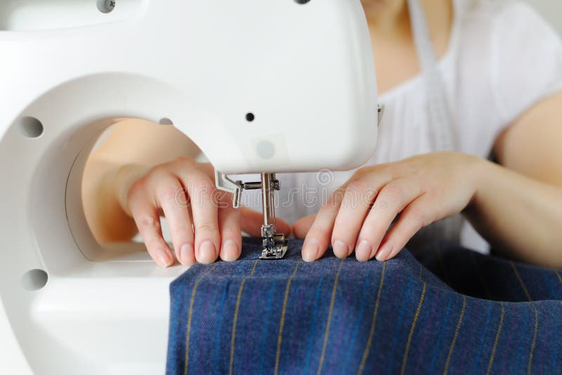 Tailoring of Natural Wool. Woman Tailor Working on Sewing Machine ...