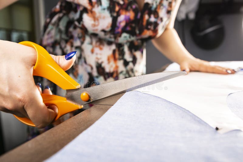 Tailoring. the Seamstress Cuts the Material with Sewing Scissors Stock ...