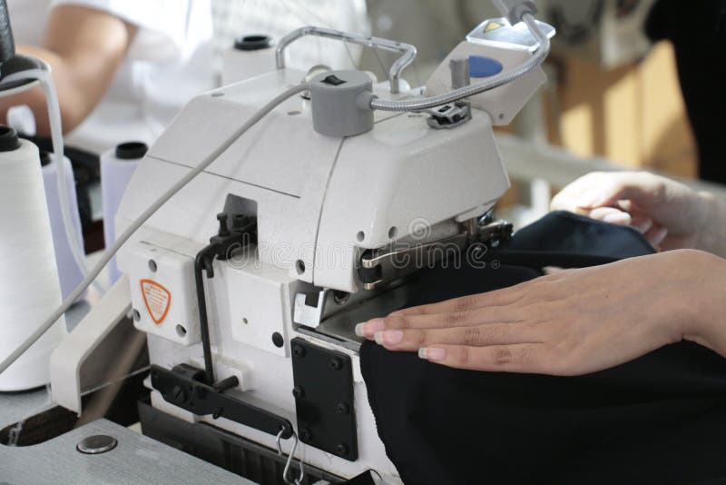 Tailors Hand on the Black Fabric in Sewing Machine Stock Photo - Image ...