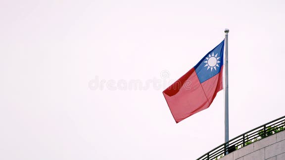 Taiwan Flag Waving a Top a Modern Building with Empty Copy Space for ...