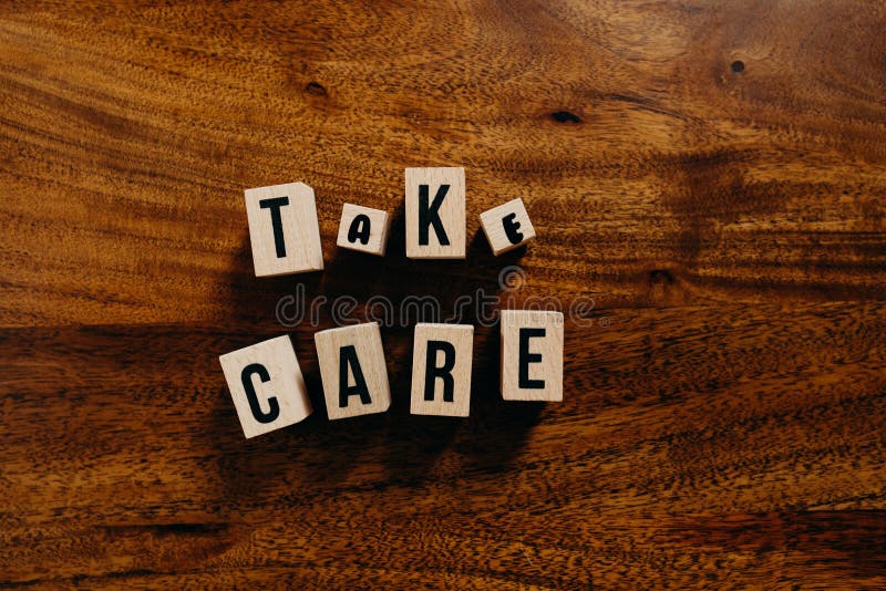 `Take Care` Text Made of Wooden Cube on Wooden Background Stock Photo ...
