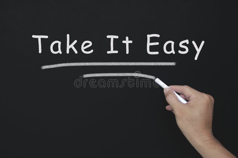 Take it Easy Text on Blackboard with Hand Holding Chalk. Stock Photo ...