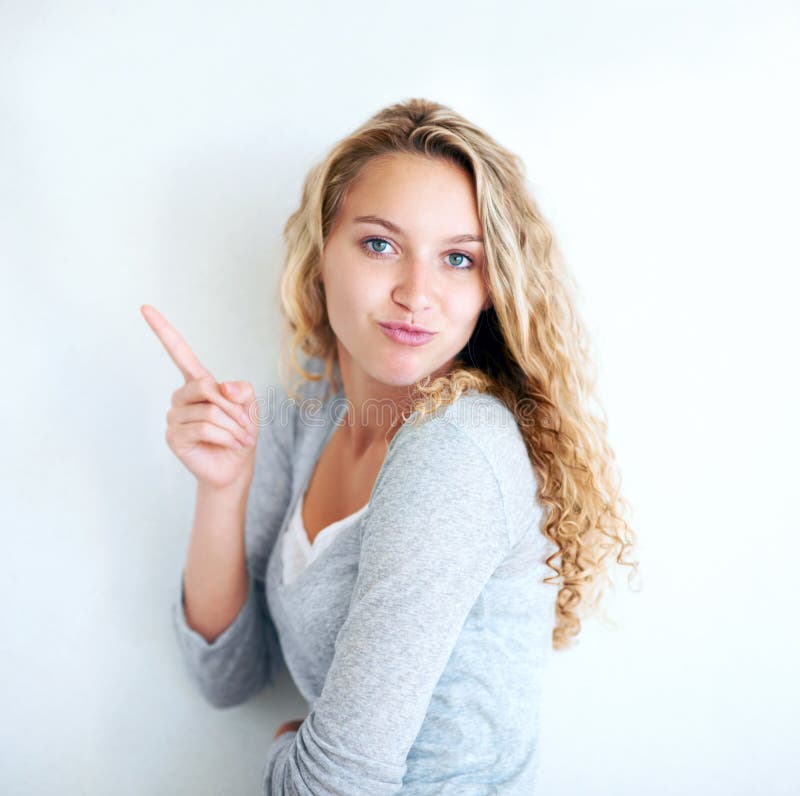 Take a Look. a Pretty, Vivacious Blonde Looking at You and Pointing ...