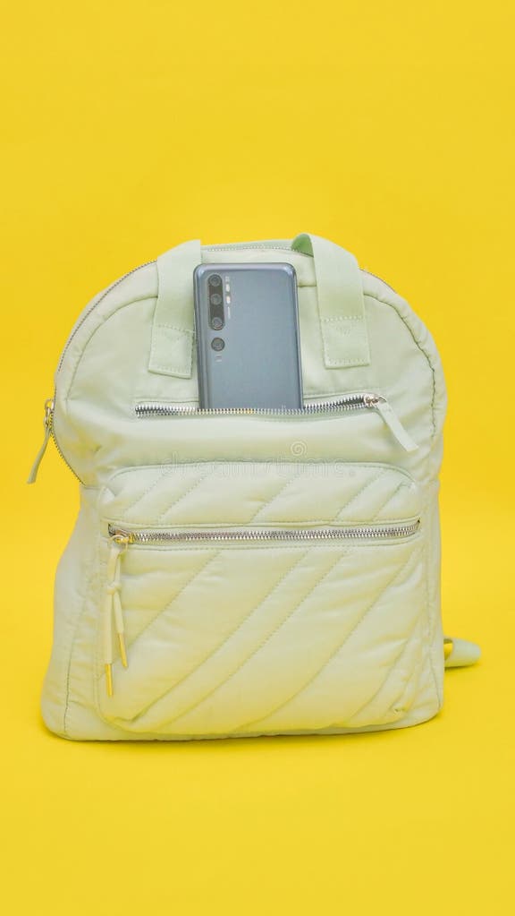 Take Out a Mobile from a Backpack, a Turquoise Backpack on a Yellow ...