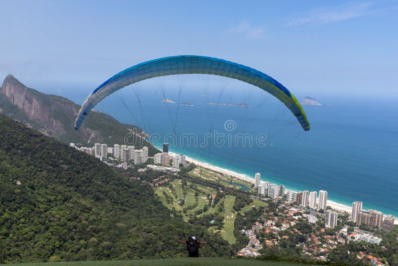 Paragliding Takeoff To Fly Over the Beach Next To Mountains Stock Photo ...