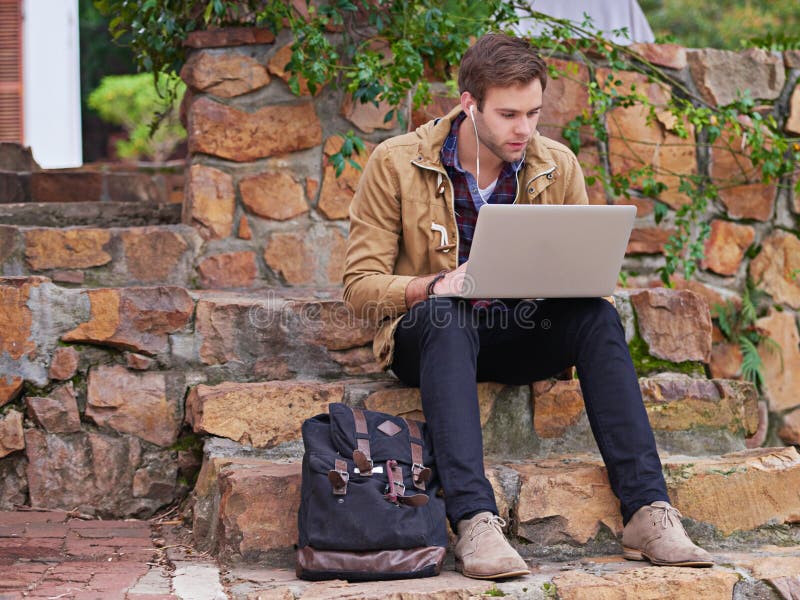 He Takes His Studies Seriously. a Handsome Male Student Using His ...