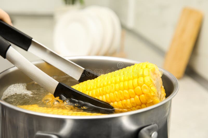 Taking Boiled Corn from Pot with Tongs in Kitchen Stock Photo - Image ...