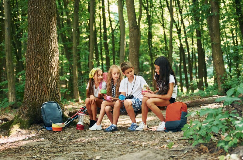 Taking a Break. Kids Strolling in the Forest with Travel Equipment ...