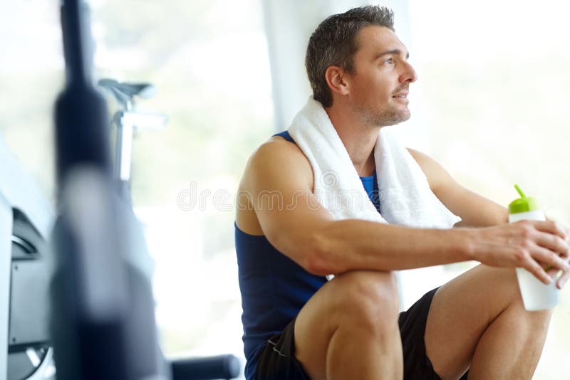 Taking a Break between Sessions. a Handsome Man Sitting at the Gym ...