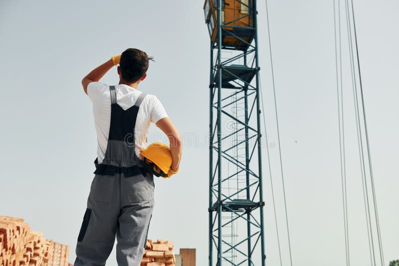 Taking a Break. Young Construction Worker in Uniform is Busy at the ...