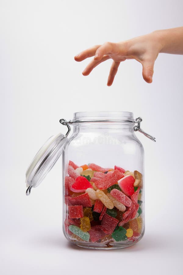 Taking candy from a jar stock image. Image of candy, right - 17717429
