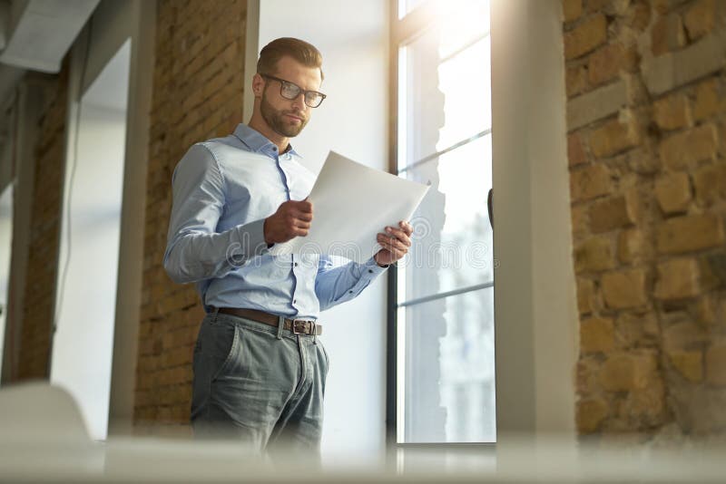 Taking Careful Look at the Working Documents by the Window Stock Photo ...